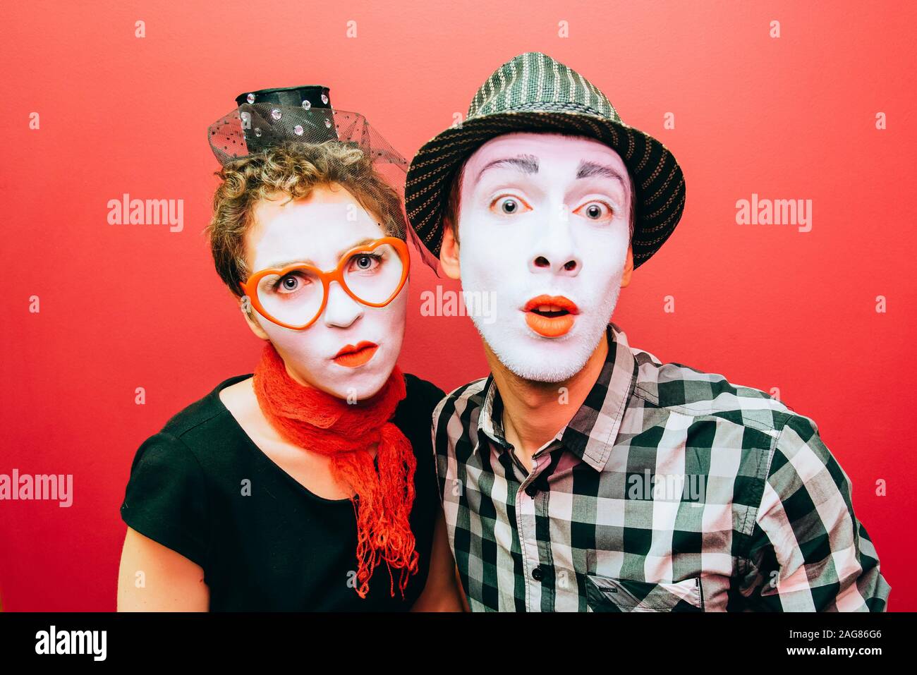 two mimes showing emotions on the wall background Stock Photo - Alamy