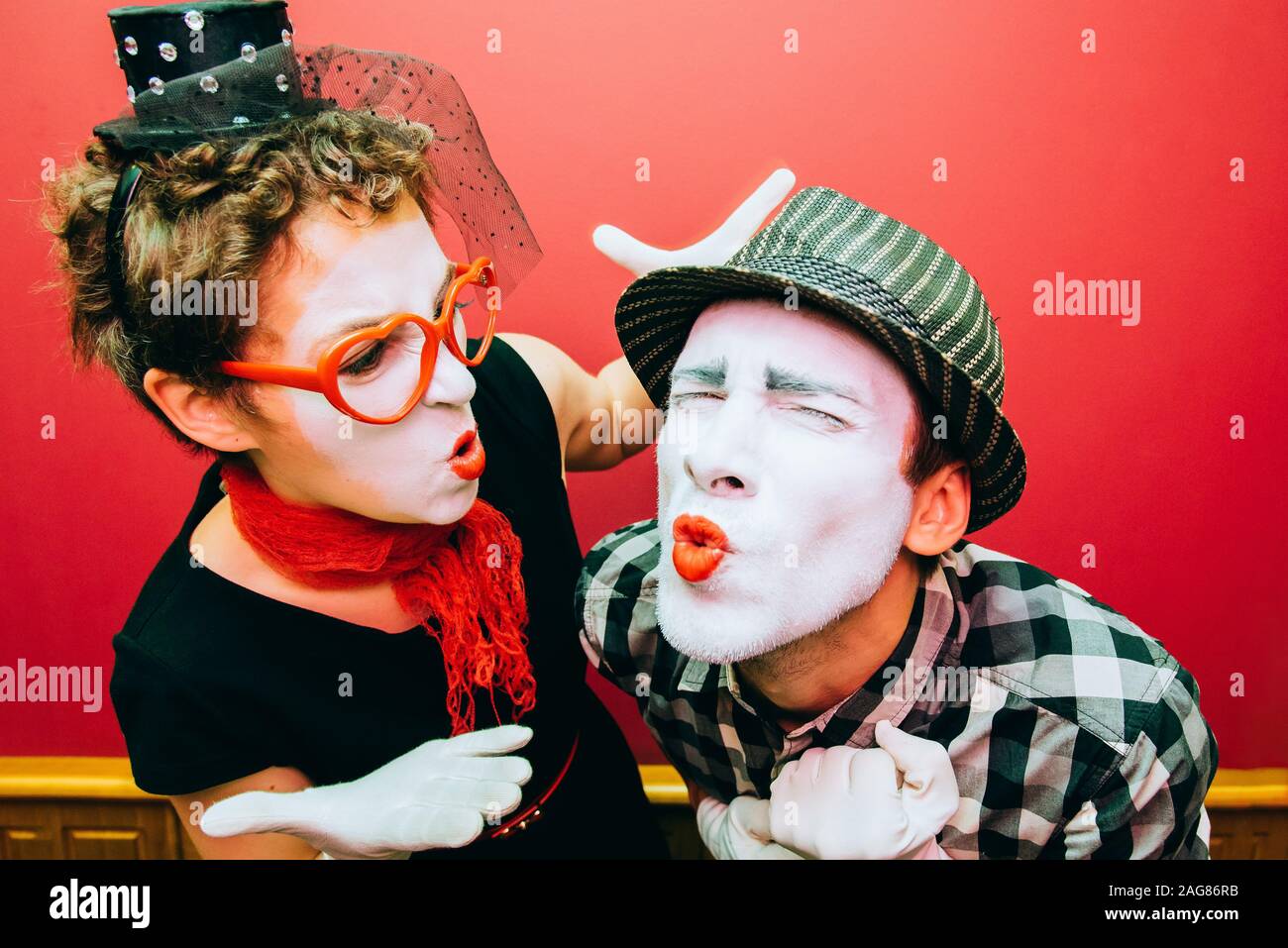 two mimes showing emotions on the wall background Stock Photo - Alamy