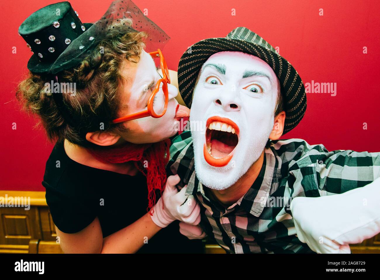 two mimes showing emotions on the wall background Stock Photo - Alamy