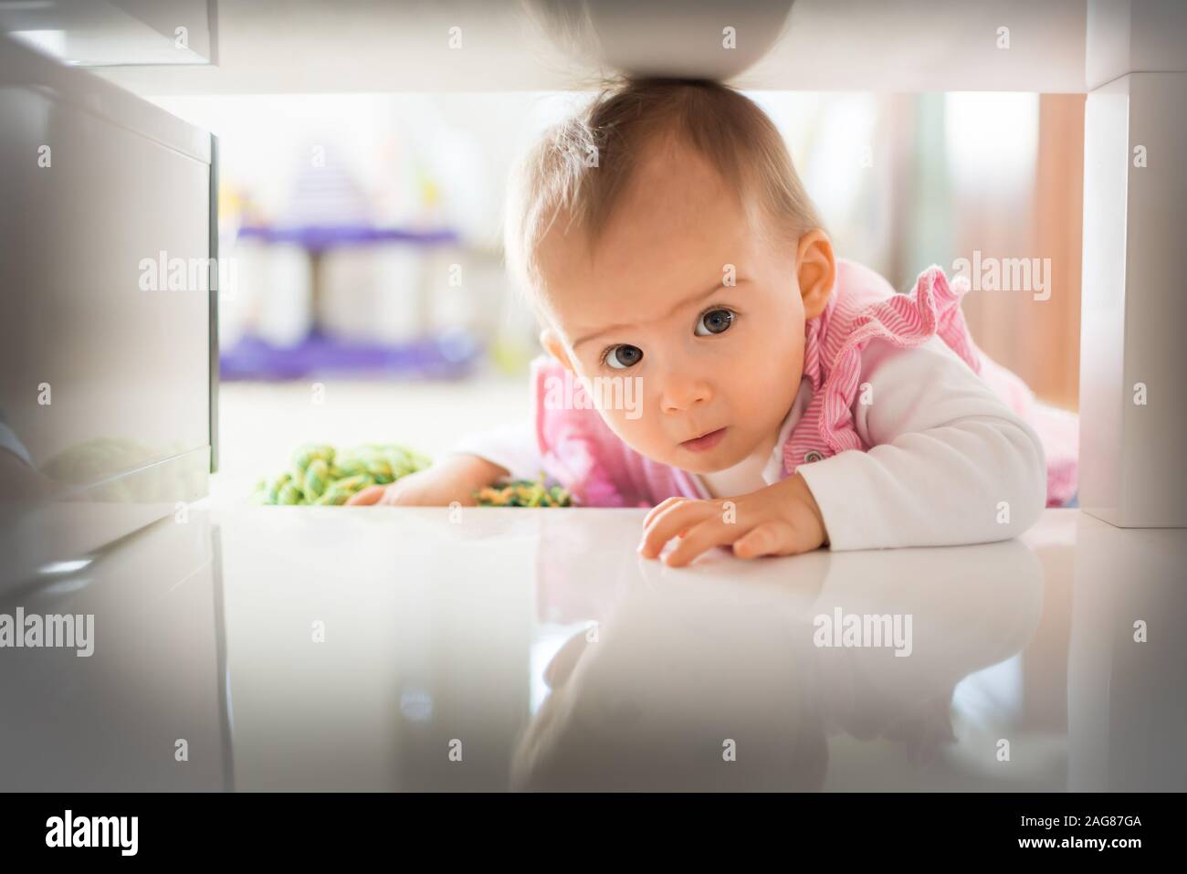 Baby looking under table hi-res stock photography and images - Alamy