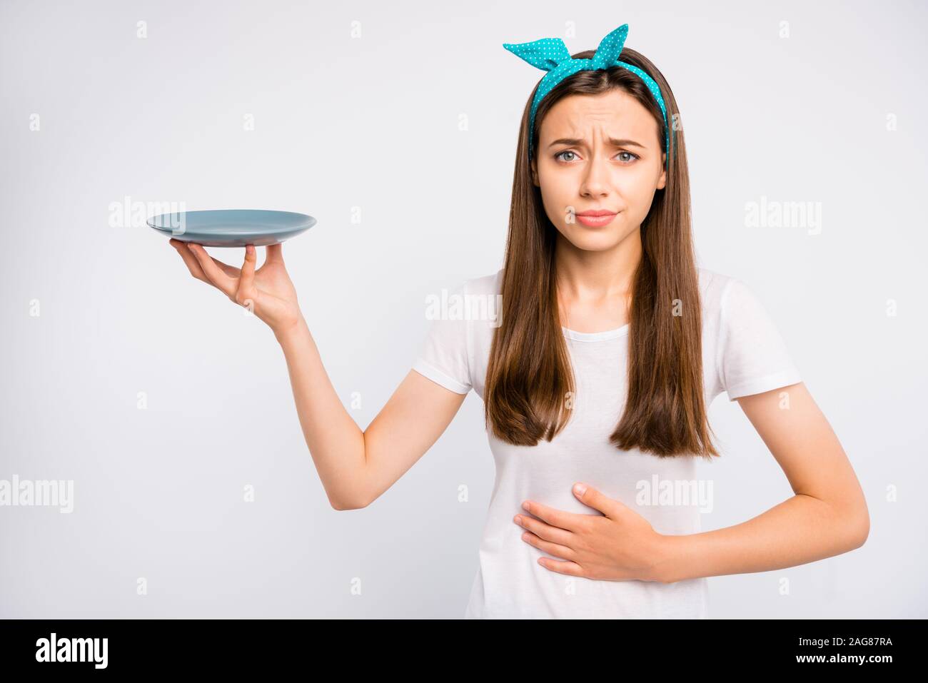 Portrait Of Sad Upset Girl Hold Hand Feel Hungry Have Stomach Ache Want