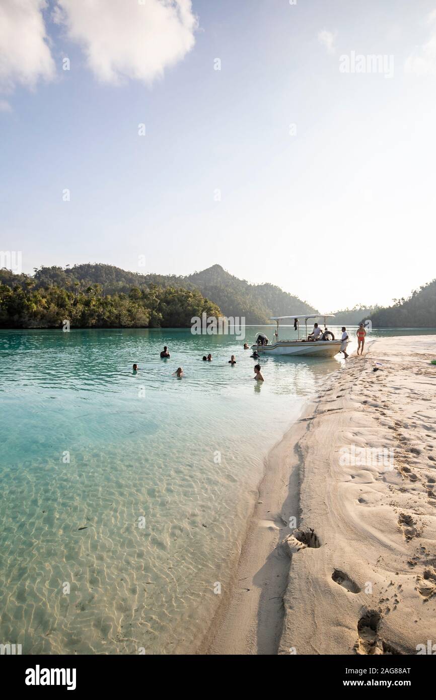 guest swimmers in shallow inlet water tropical island Raja Ampat ...
