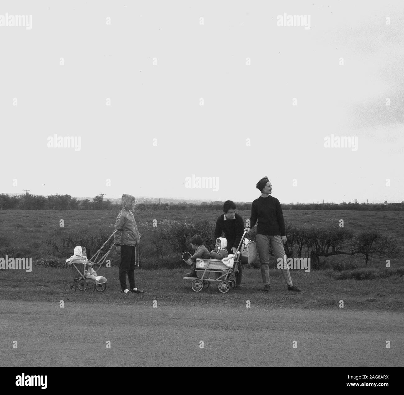 1963, historical, a family with their young children, two in a ...