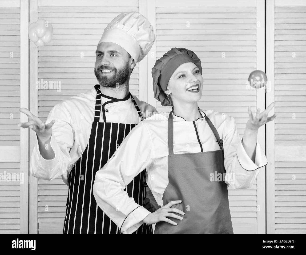 playful culinary master. Family cooking in kitchen. happy couple in ...