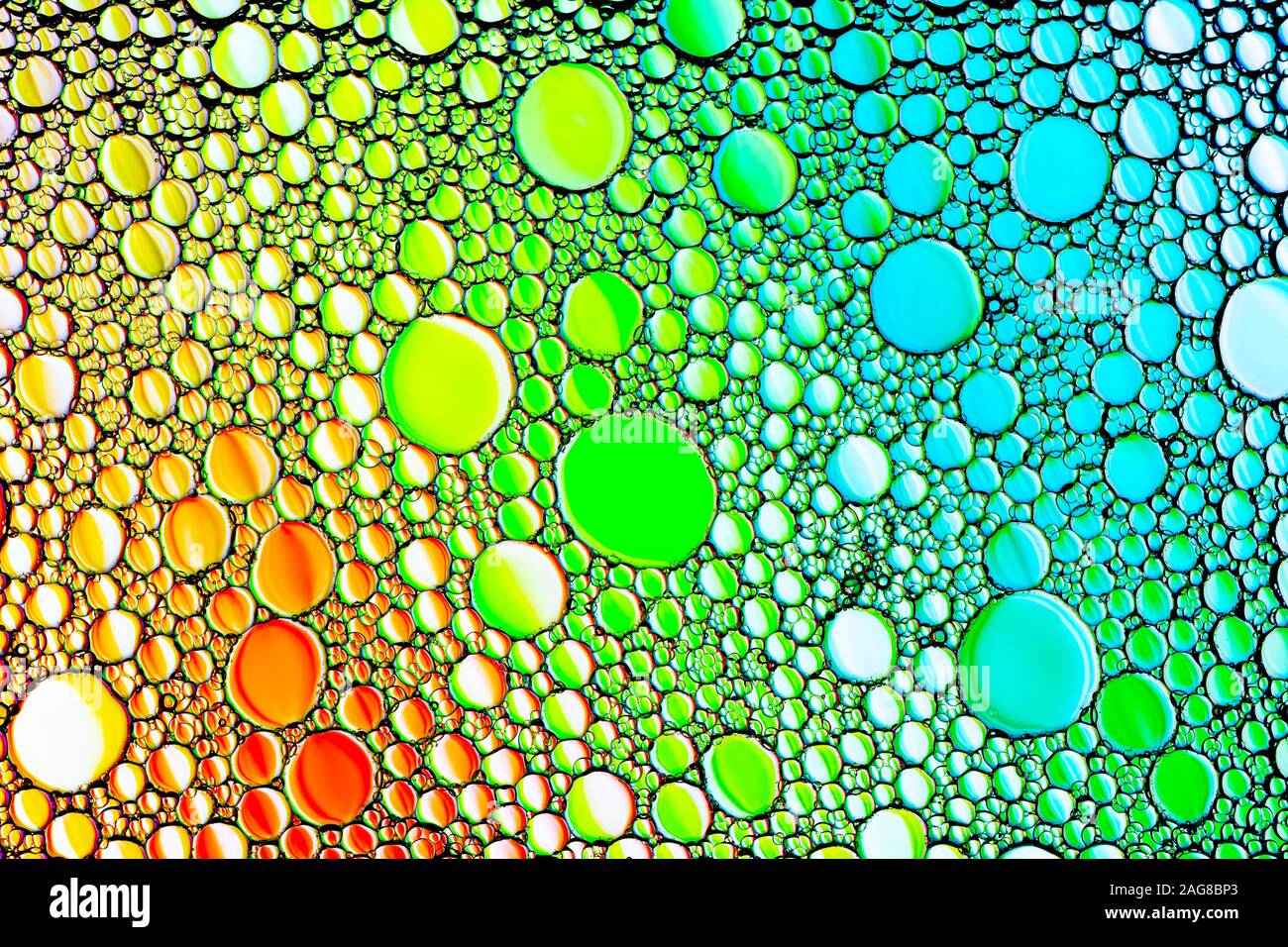 Colorful drops of oil on the water. Circles and ovals. Abstract bright ...