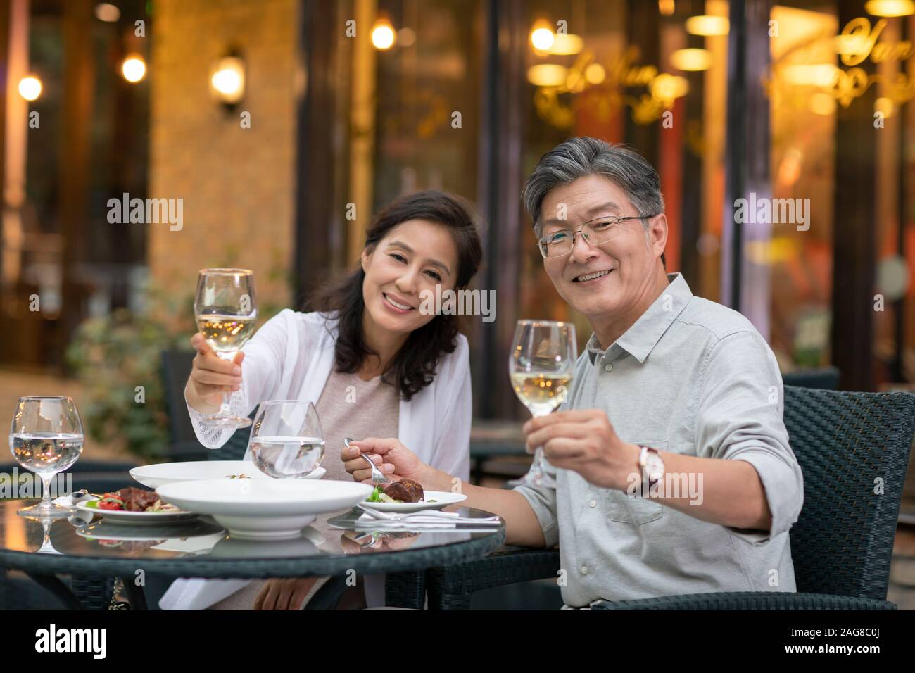 Mature Chinese couple toasting at restaurant Stock Photo - Alamy