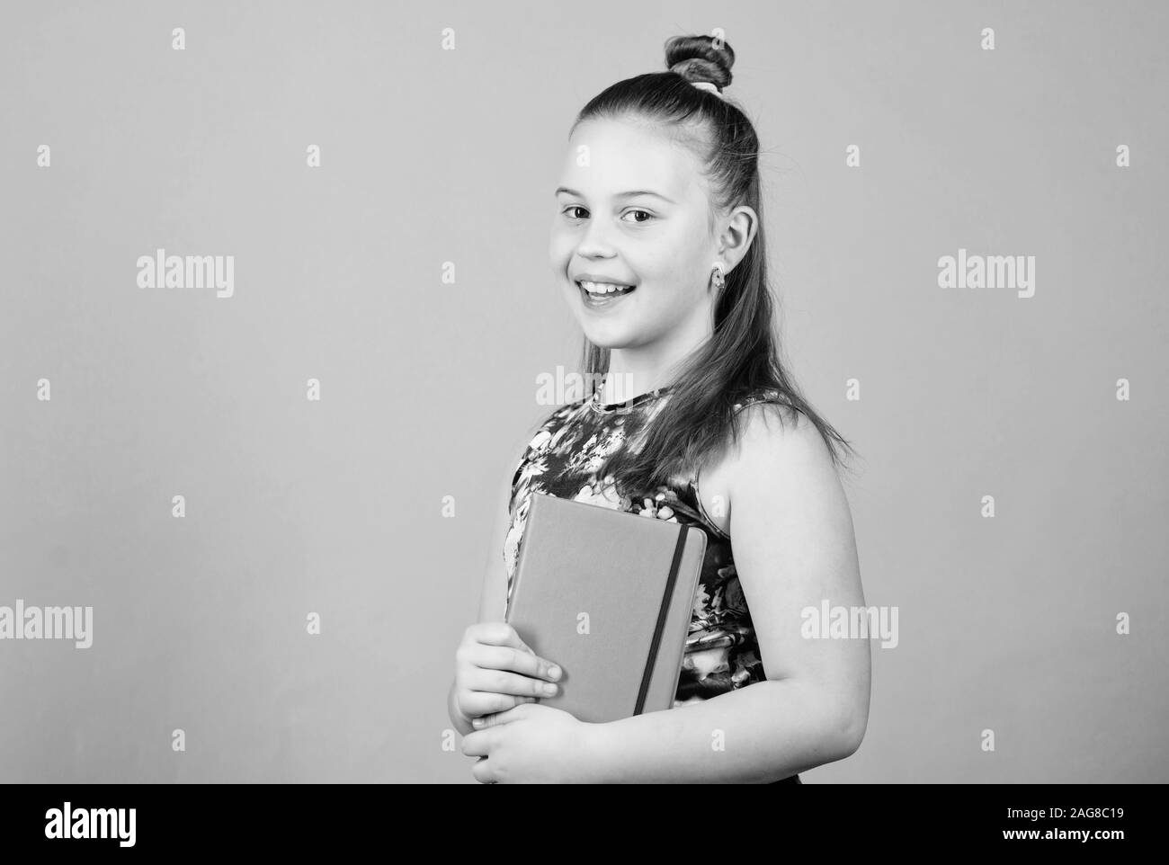 small girl with pink note book. school child with notepad. Smart and ...
