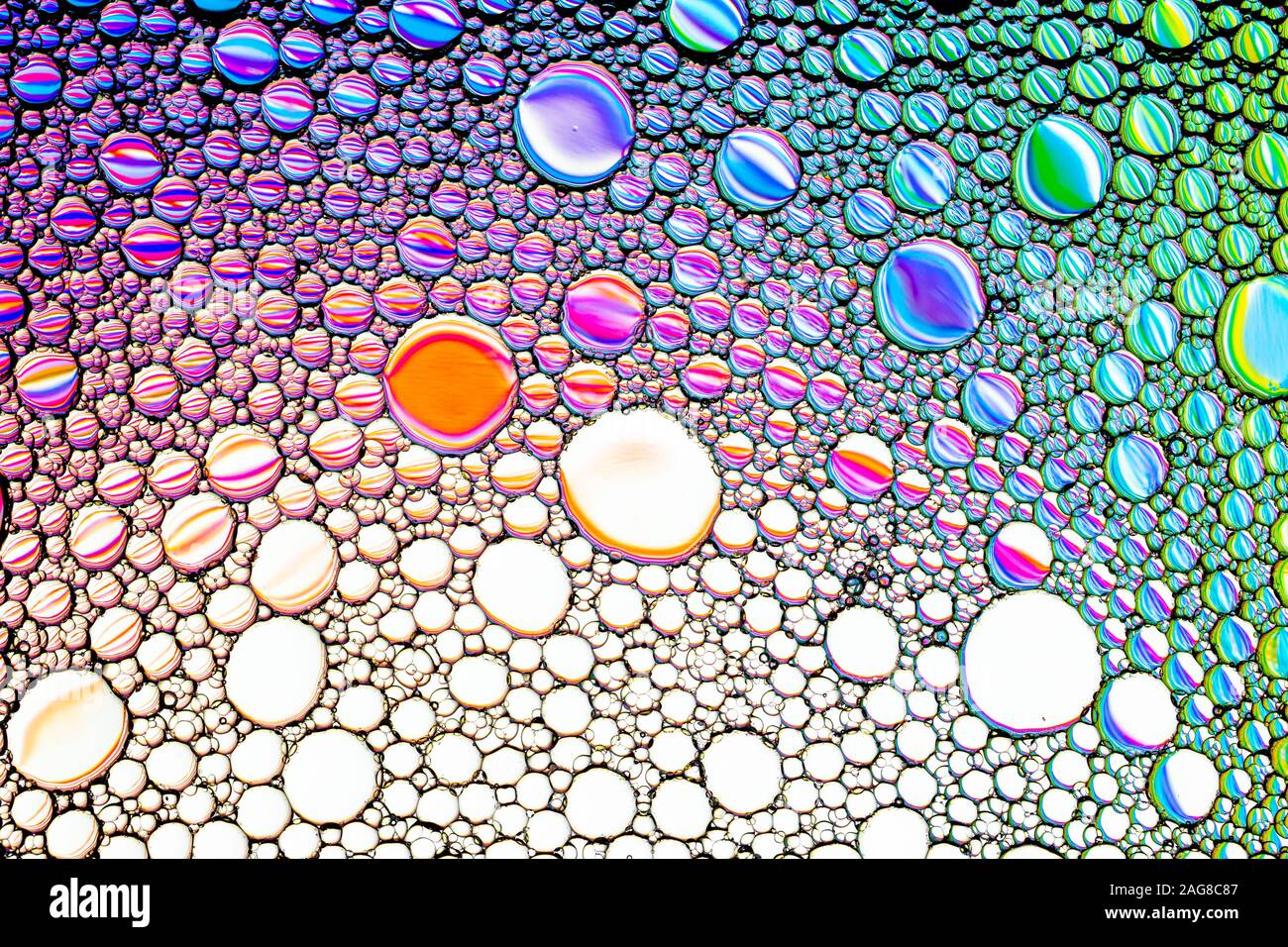 Colorful drops of oil on the water. Circles and ovals. Abstract bright ...