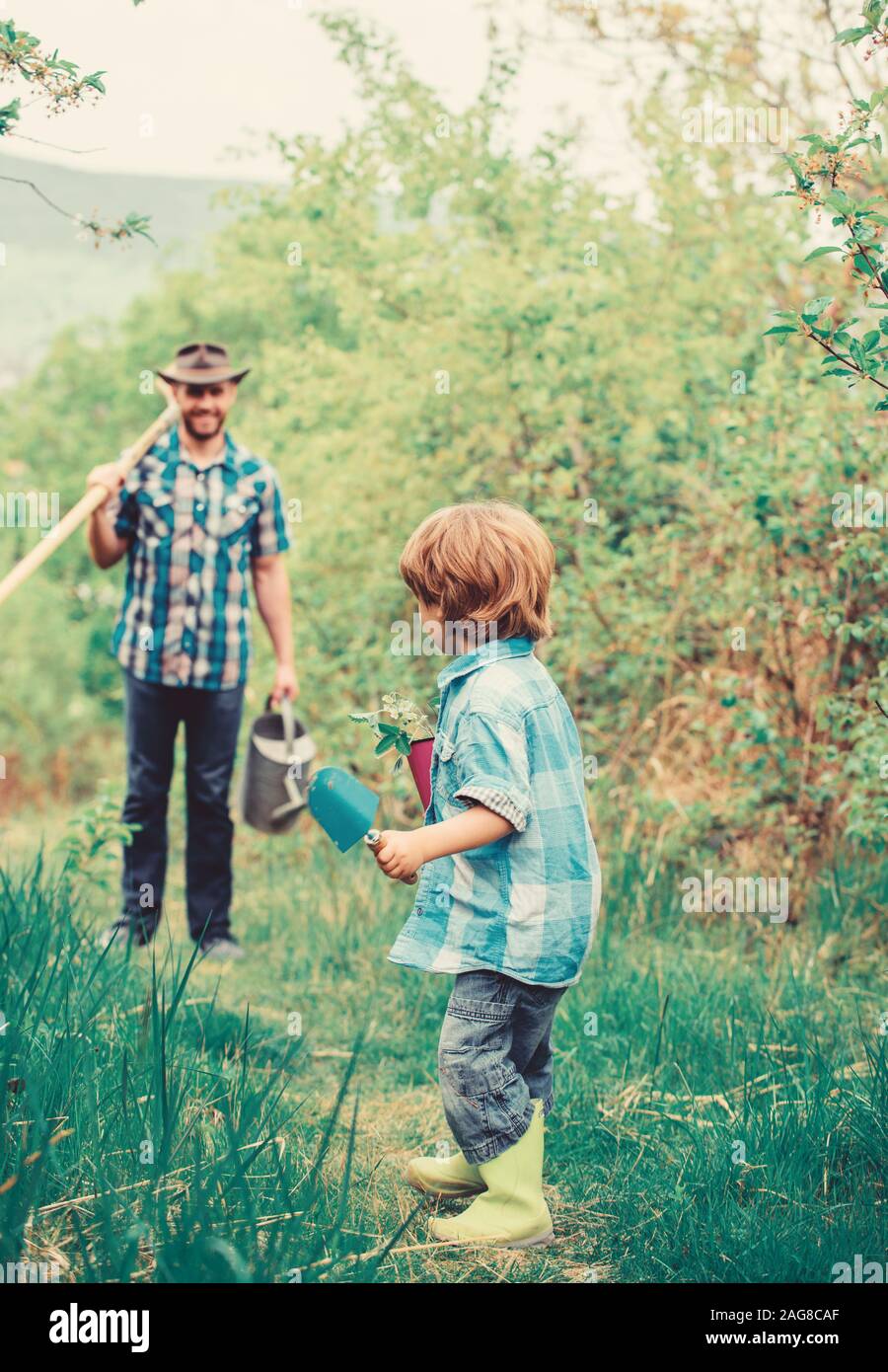 small boy child help father in farming. happy earth day. Family tree ...