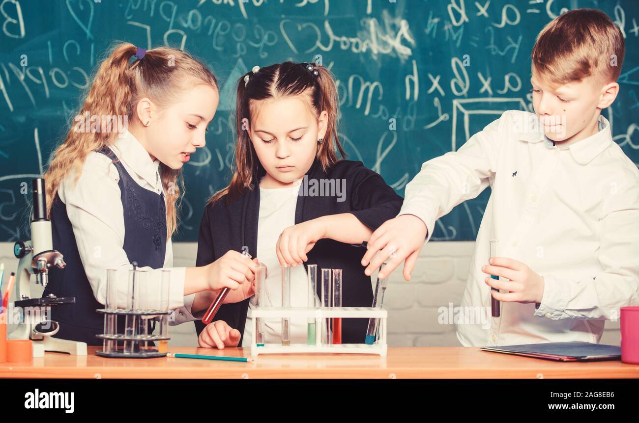 students doing biology experiments with microscope in lab. Little kids ...