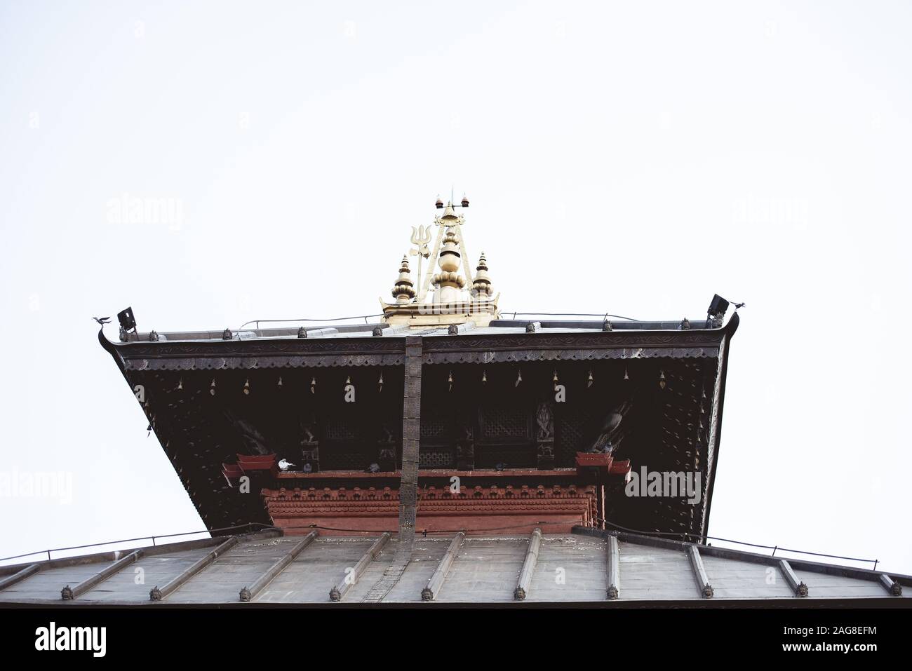Low angle shot of a Hindu temple of Nepal with a white sky in the ...