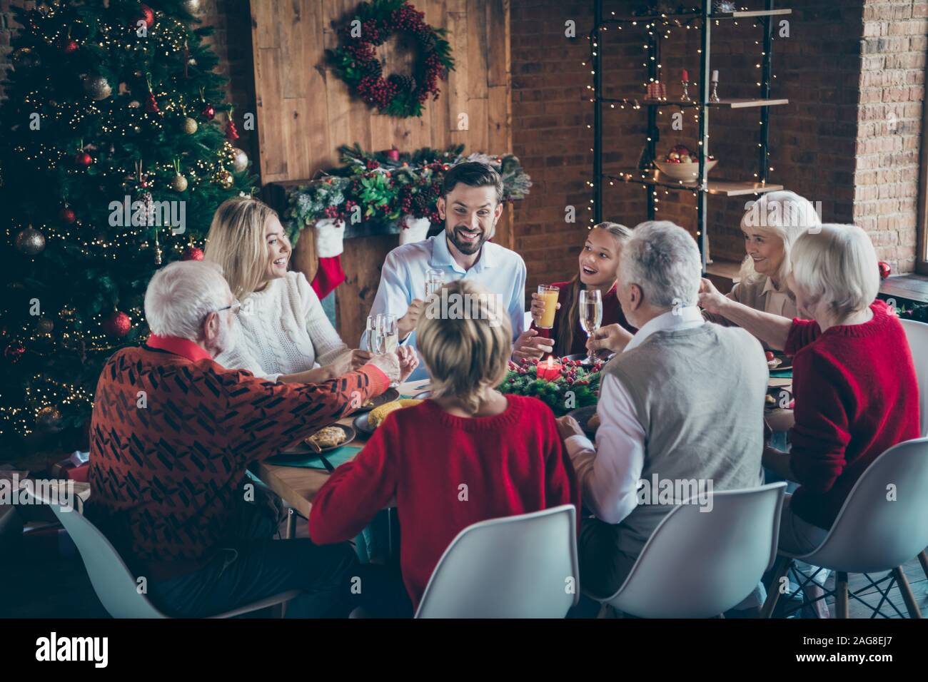Photo of full big family gathering sit dinner table telling toasts x ...