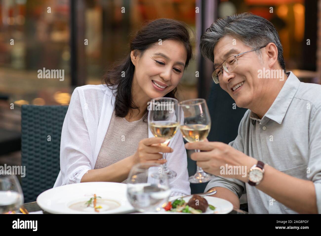 Mature Chinese couple toasting at restaurant Stock Photo - Alamy