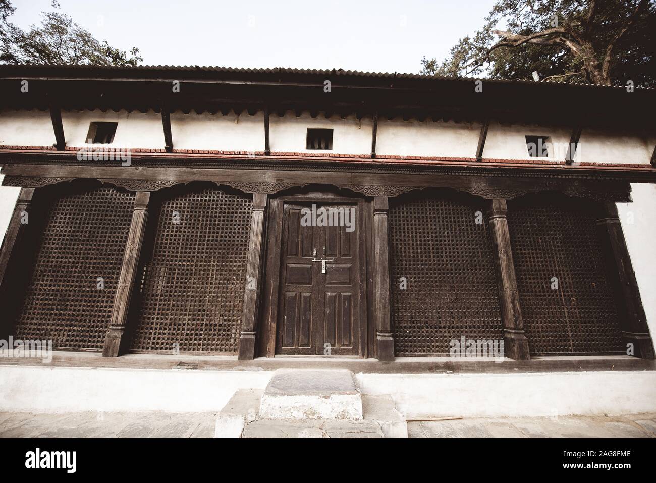 Low angle shot of a Hindu temple with wooden doors and windows in Nepal ...