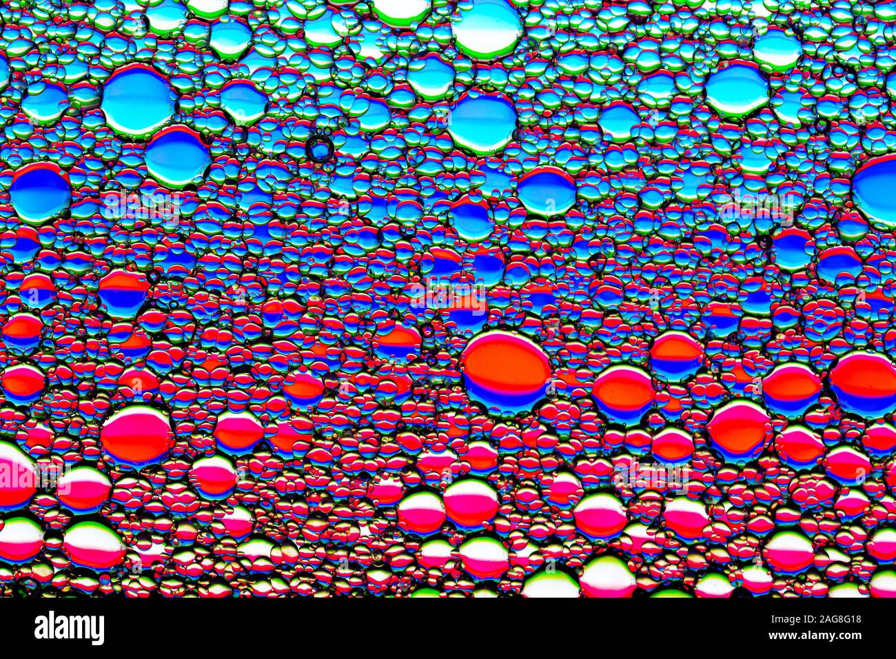 Colorful drops of oil on the water. Circles and ovals. Abstract bright ...