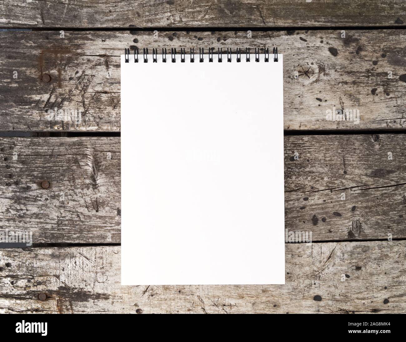 open notepad with clean white page on the aged old rustic wooden table ...