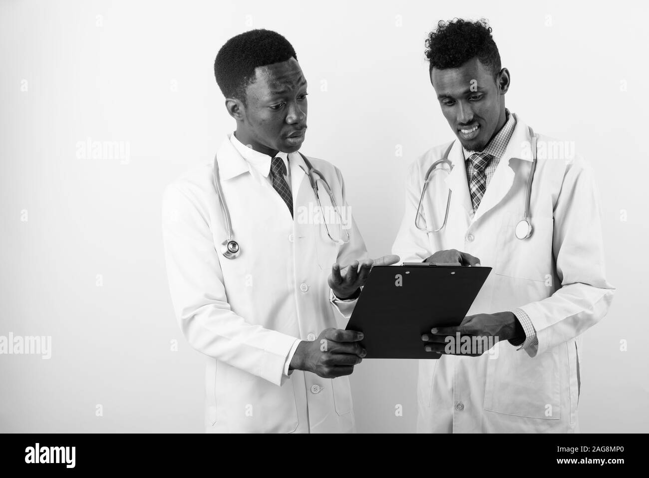 Two young African man doctors against white background Stock Photo - Alamy