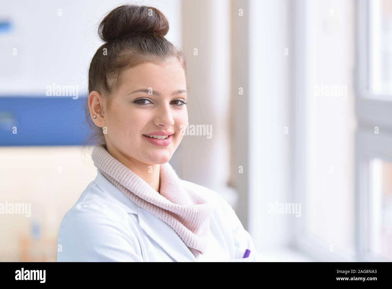 Young female male scientist in a laboratory doing research ...