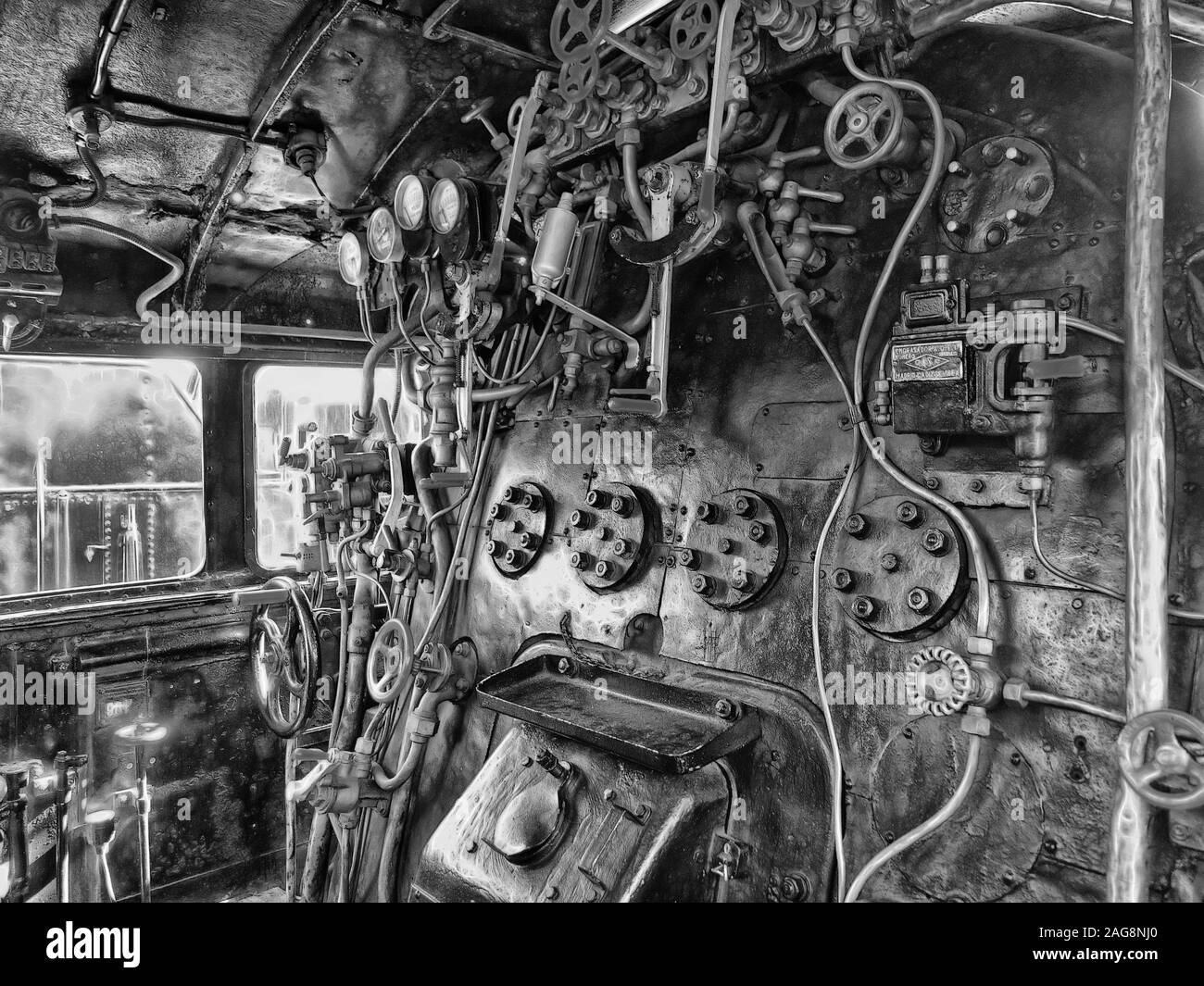 Grayscale shot of an interior steam engine in the railroad museum of ...