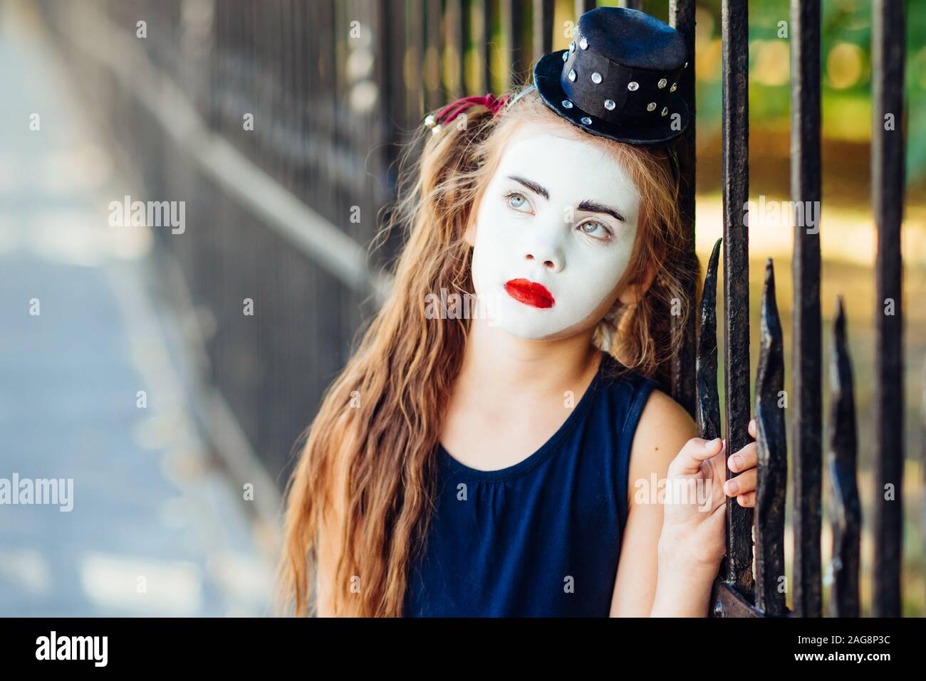 little mime girl standing by the fence Stock Photo - Alamy