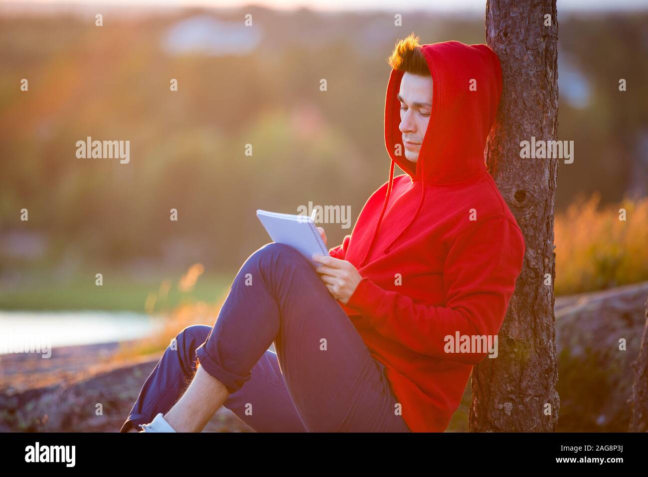 Young man write book outdoor hi-res stock photography and images - Alamy