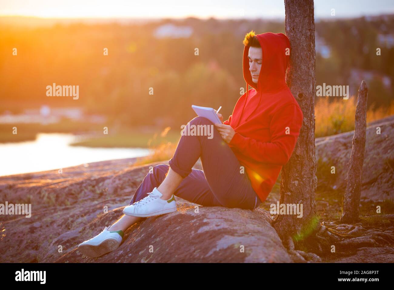 Young man write book outdoor hi-res stock photography and images - Alamy