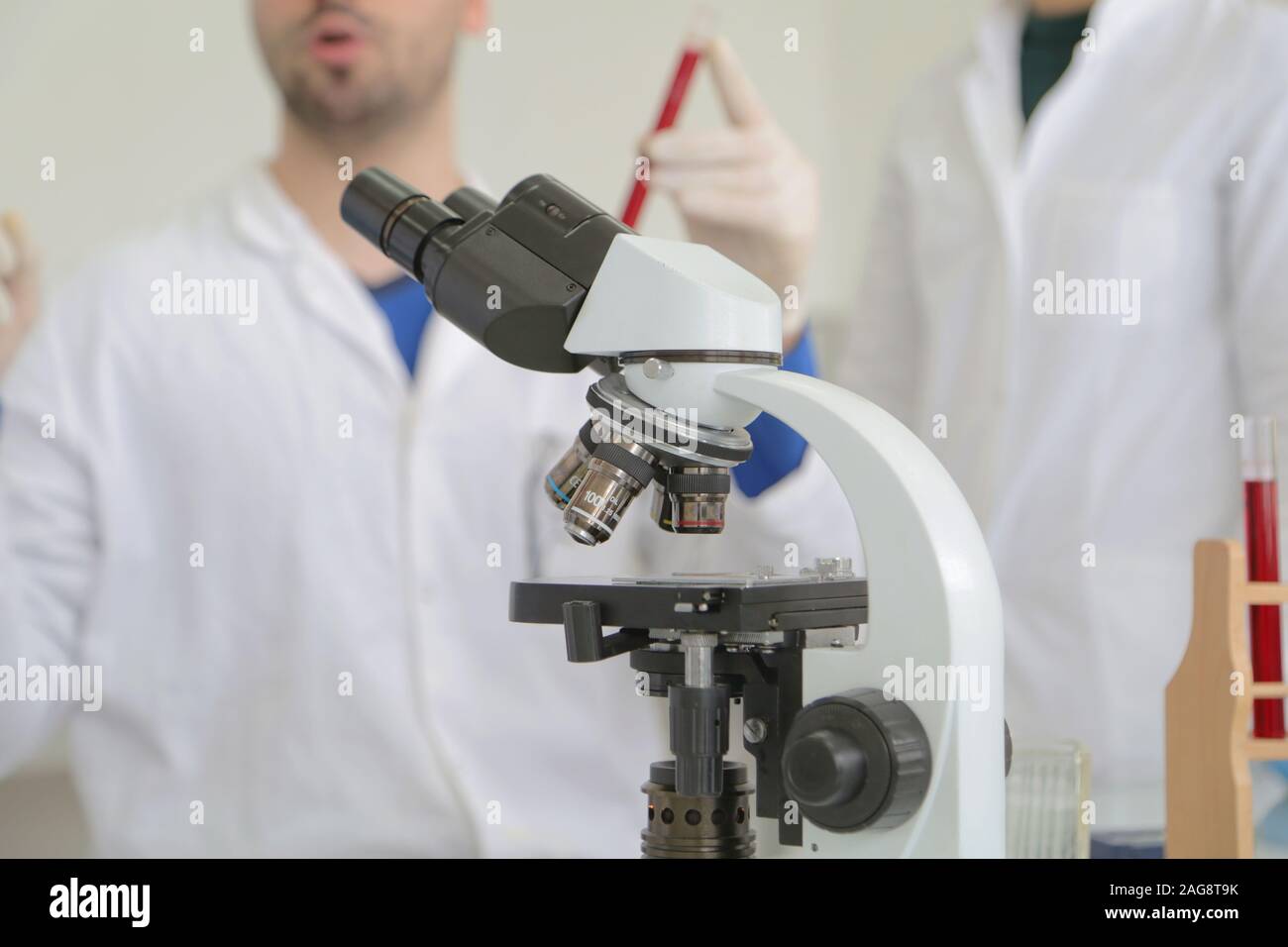 Group of young Laboratory scientists working at lab with test tubes and ...