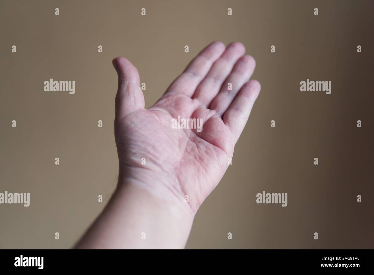 Open human palm on blurred background - support concept Stock Photo - Alamy