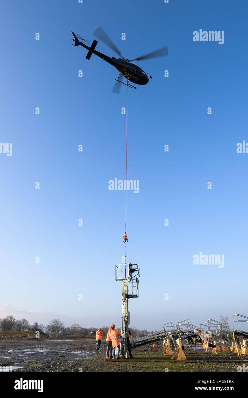 Sande, Germany. 18th Dec, 2019. Workers attach a route signal to the ...