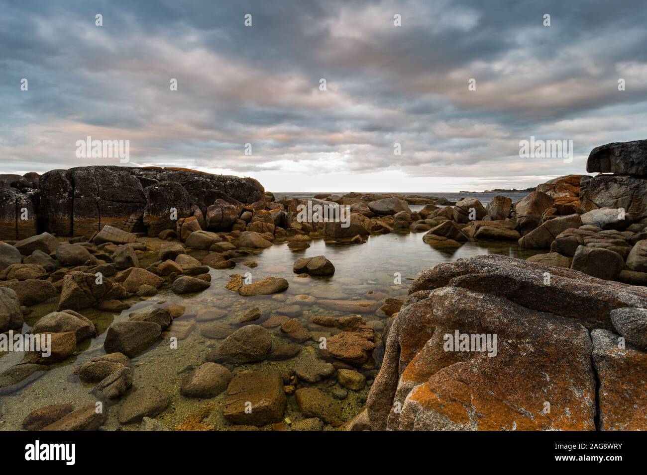 Beautiful shot of a small lake formation surrounded by stones in the ...