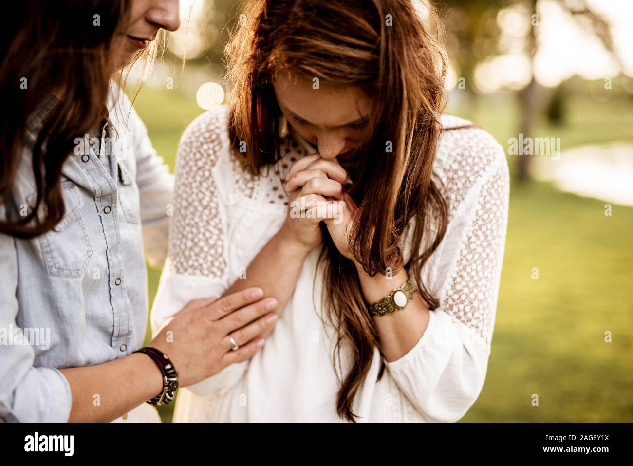 Closeup shot of two female praying with a blurred background Stock ...