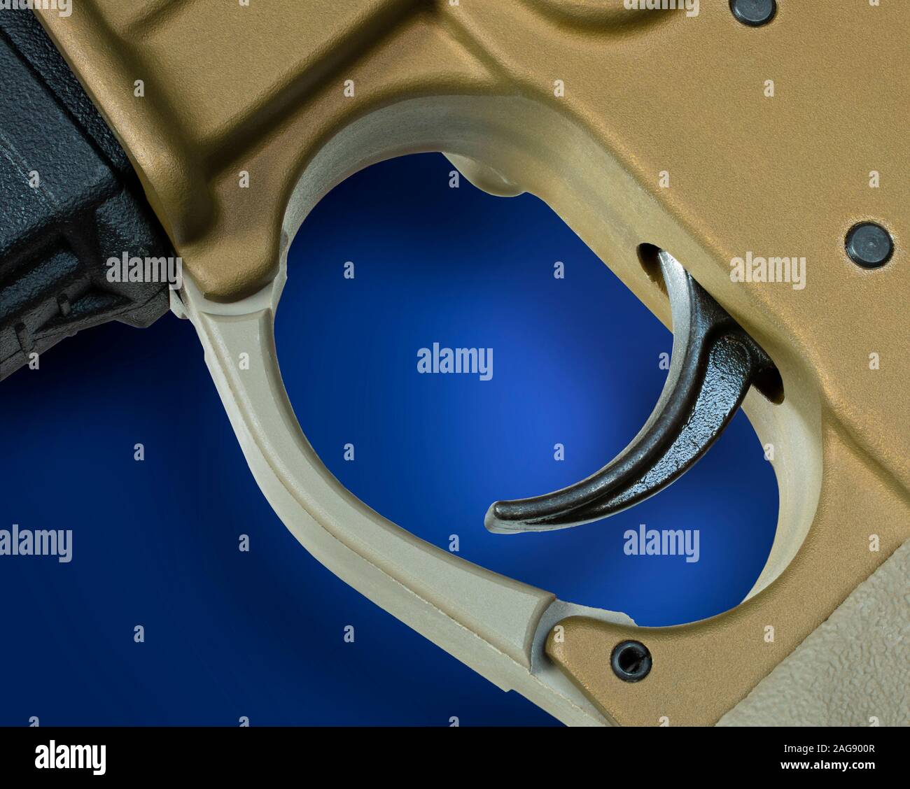 Trigger from an AR-15 assault rifle with shadown on blue Stock Photo ...