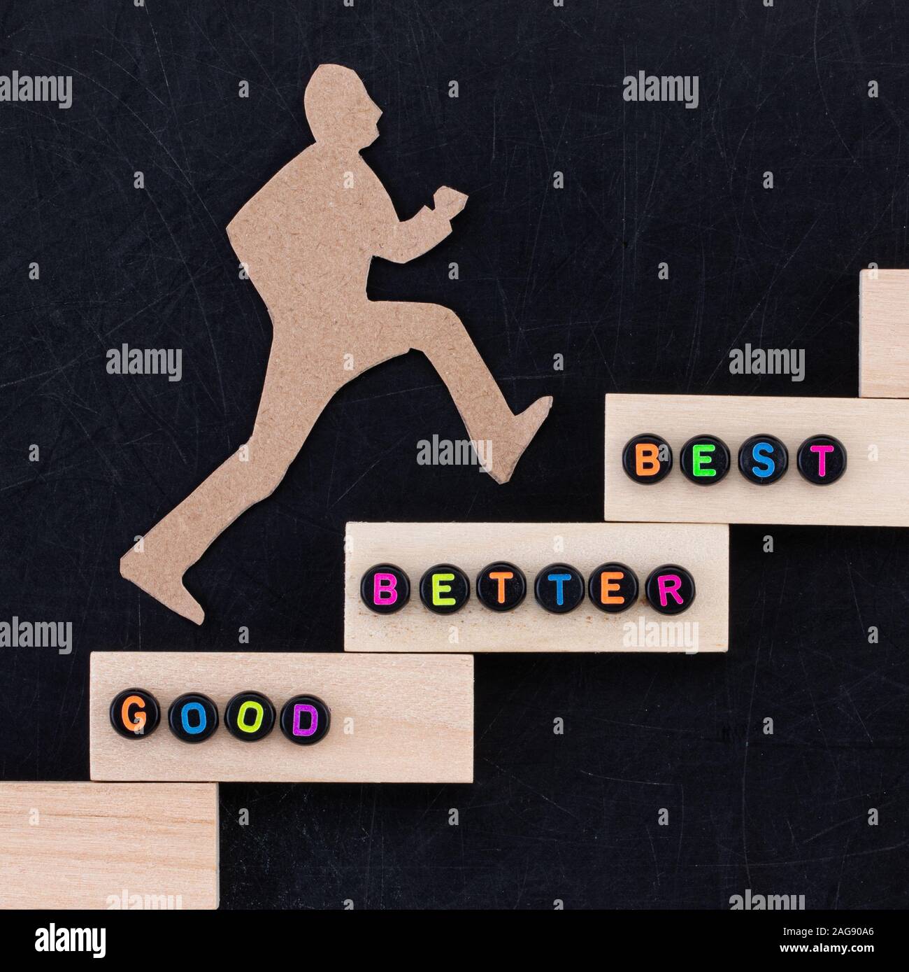 Good - Better - Best paper man climbing the steps to success in a ...