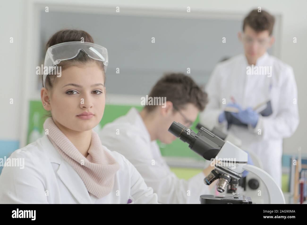 Group of young Laboratory scientists working at lab with test tubes and ...