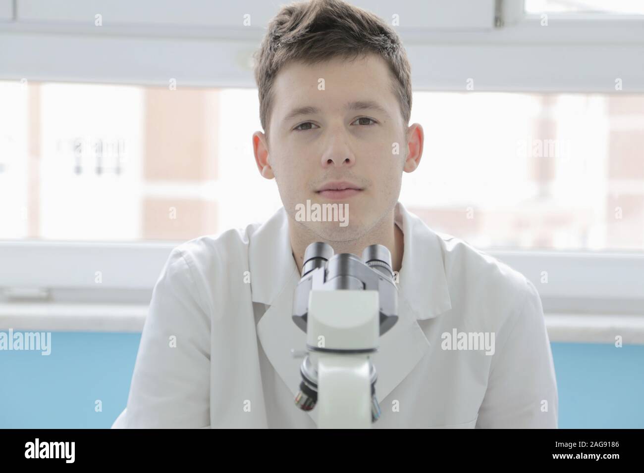 Male scientist looking and smilling into camera. Science, chemistry ...
