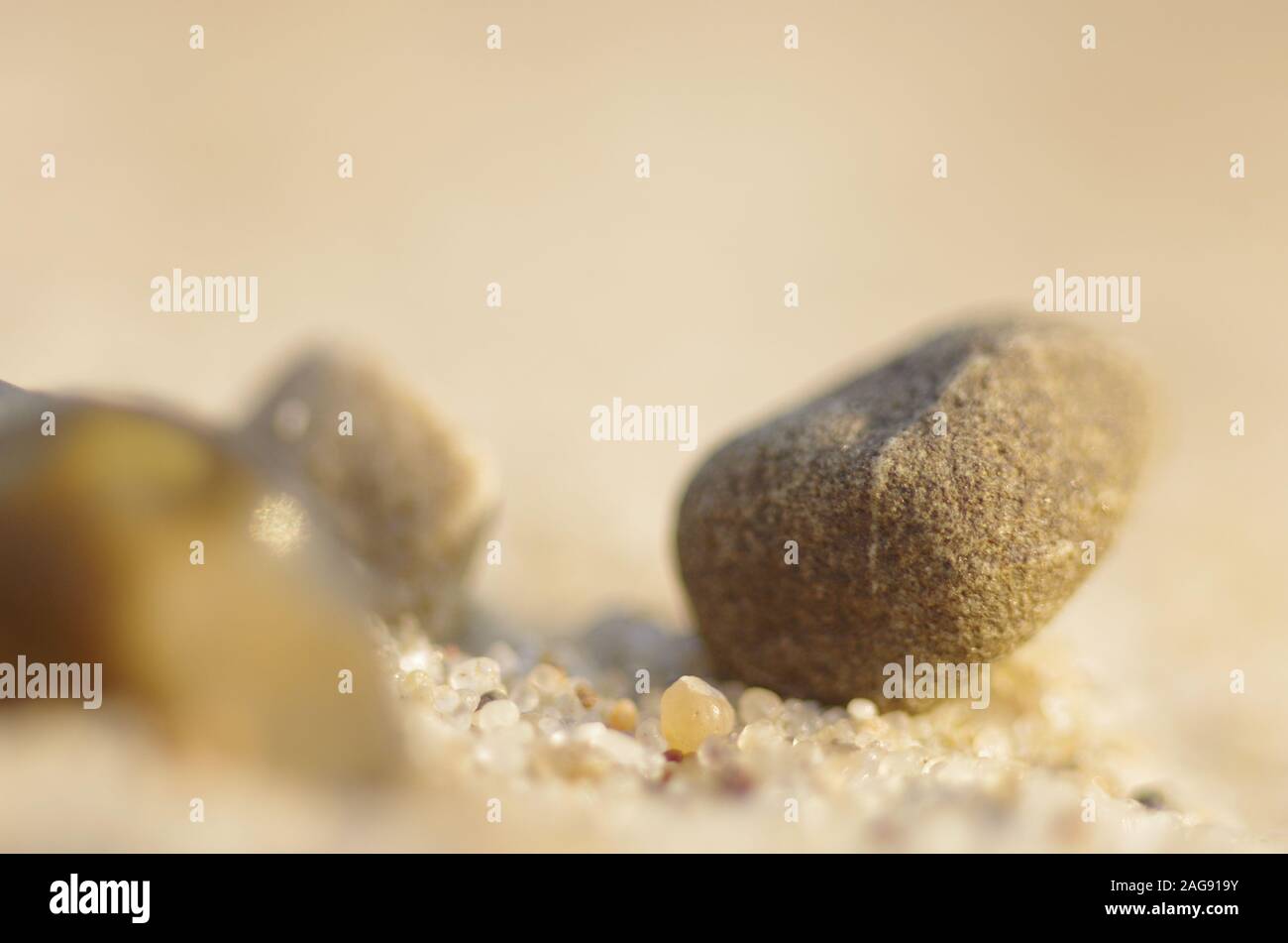 Close-up view of a small stone on sand Stock Photo - Alamy