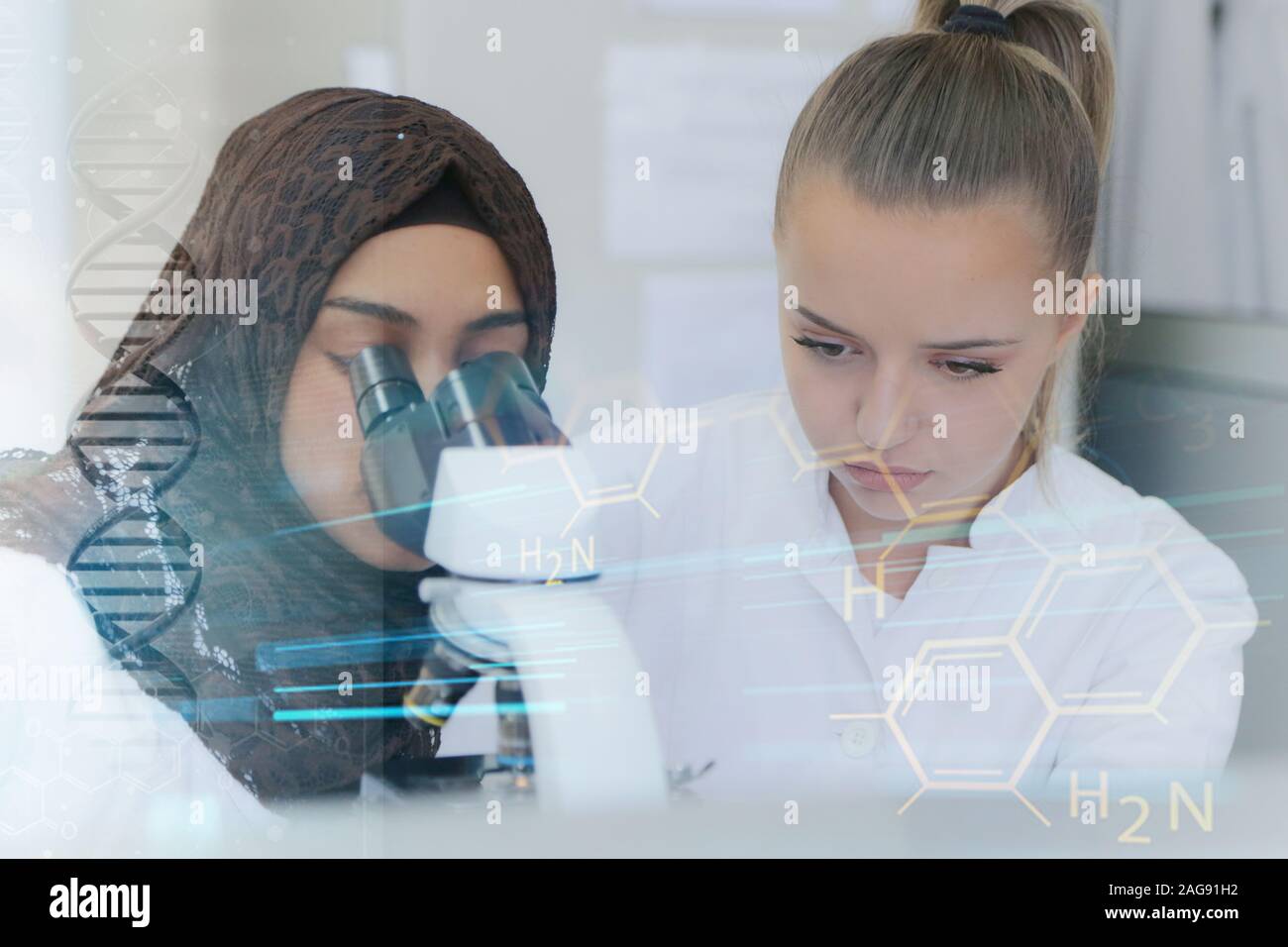 Two multiethnic young female scientists doing experiments in laboratory ...