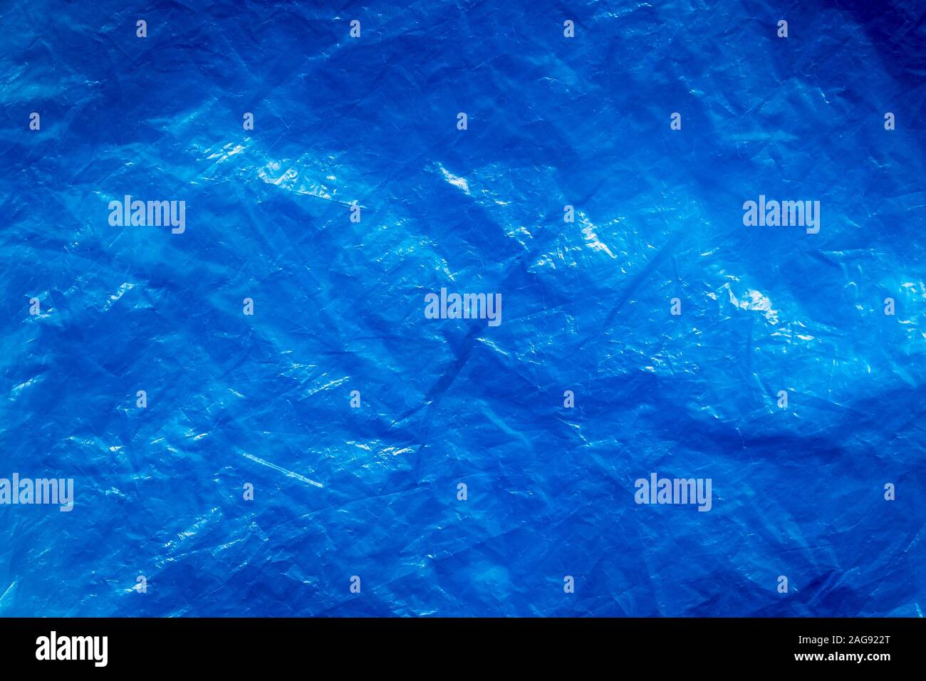 Texture of crumpled blue plastic trash bag. Abstract background for ...