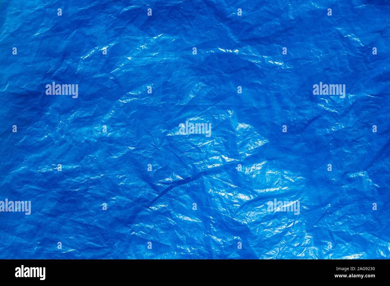 Texture of crumpled blue plastic trash bag. Abstract background for ...
