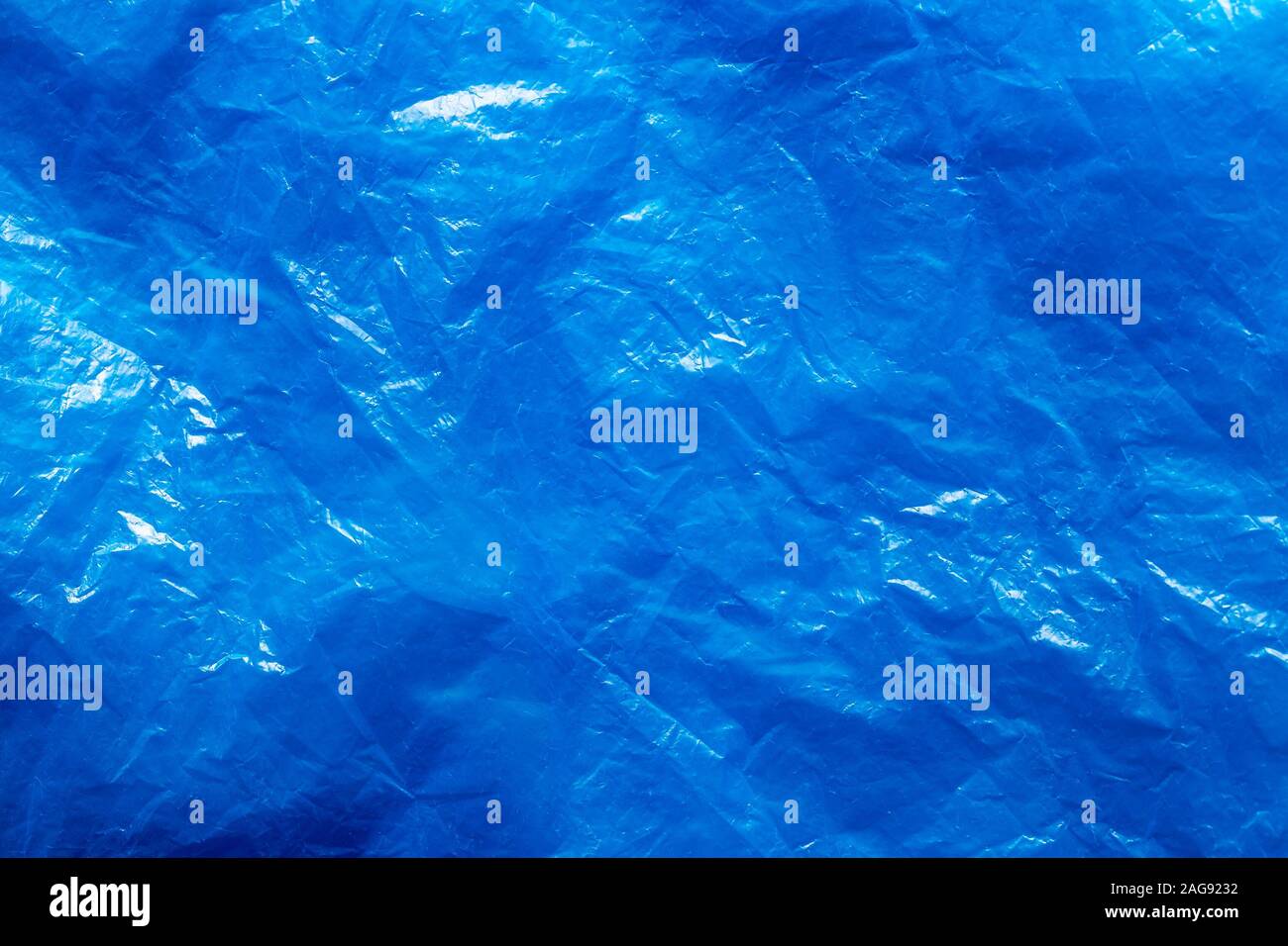 Texture of crumpled blue plastic trash bag. Abstract background for ...