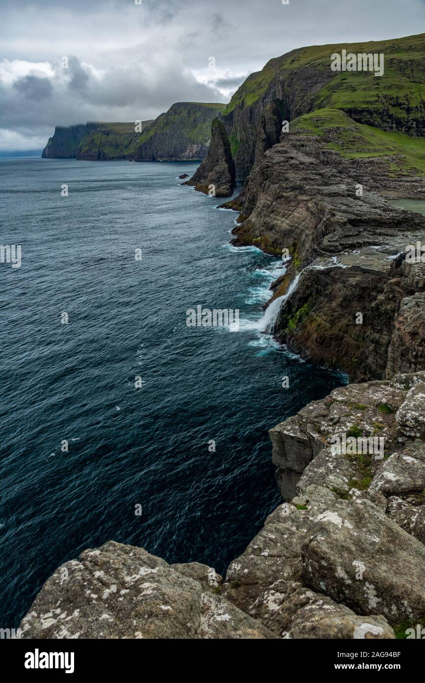 Bosdalafossur waterfall and steep coastline in Faroe Islands Stock ...