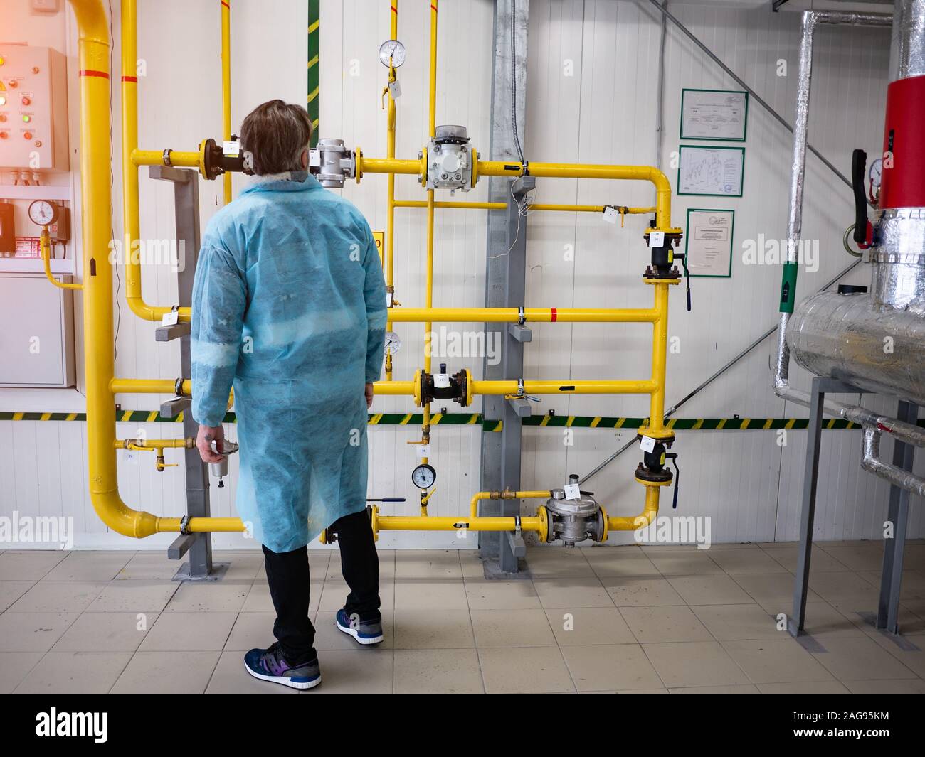 engineer examines the equipment in the boiler room Stock Photo - Alamy