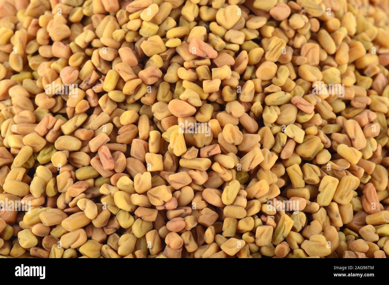 Fenugreek seeds as background. Close up texture Stock Photo - Alamy