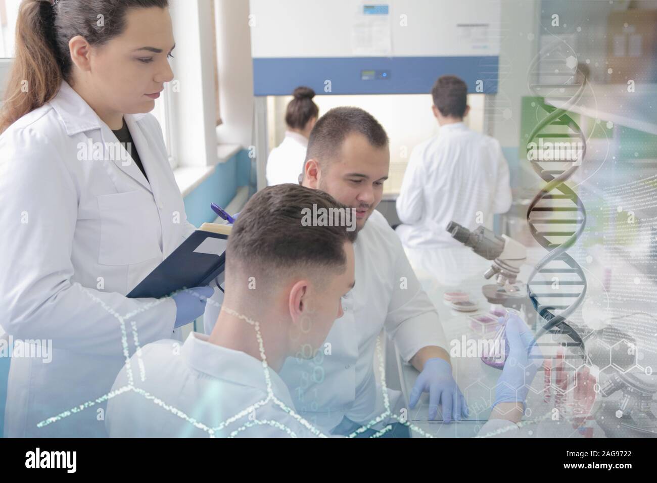Group of young Laboratory scientists working at lab with test tubes and ...