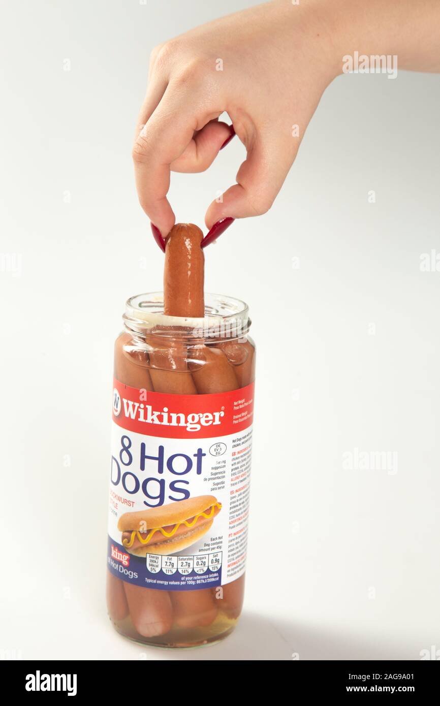 hotdog getting picked out of jar Stock Photo - Alamy