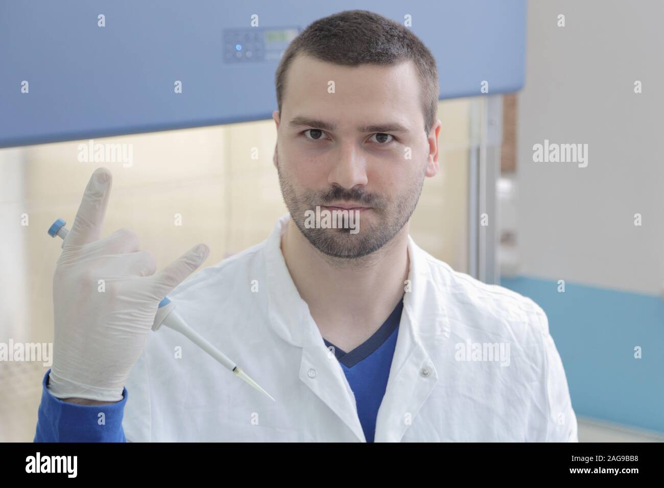 Young male Laboratory scientist working at lab with test tubes and ...
