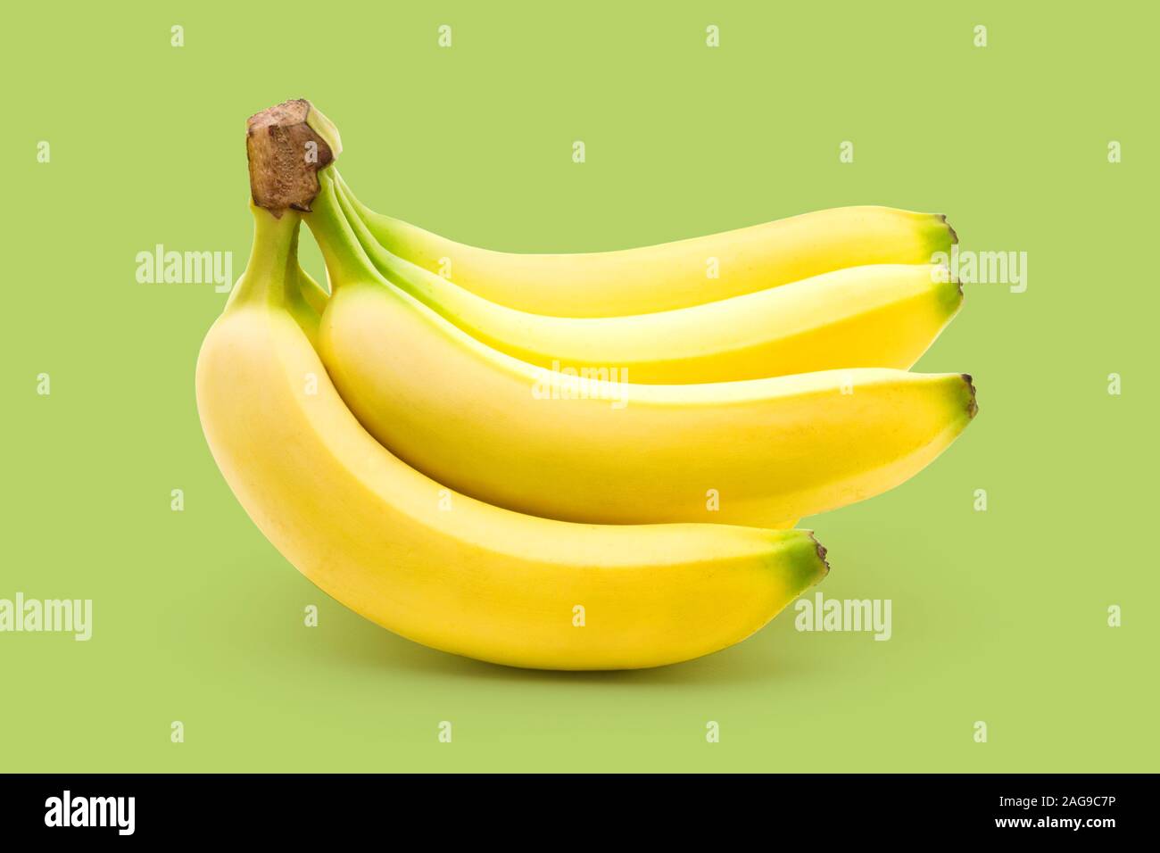 Perfect ripe bananas isolated on green background. Health, food, vegan ...