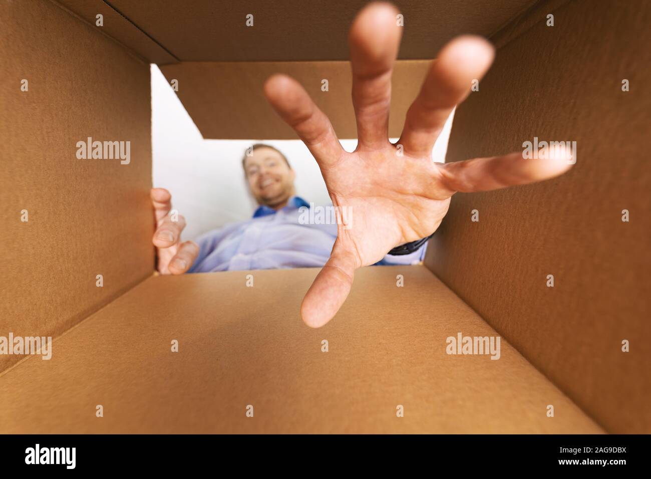 Hand reaching into box hi-res stock photography and images - Alamy