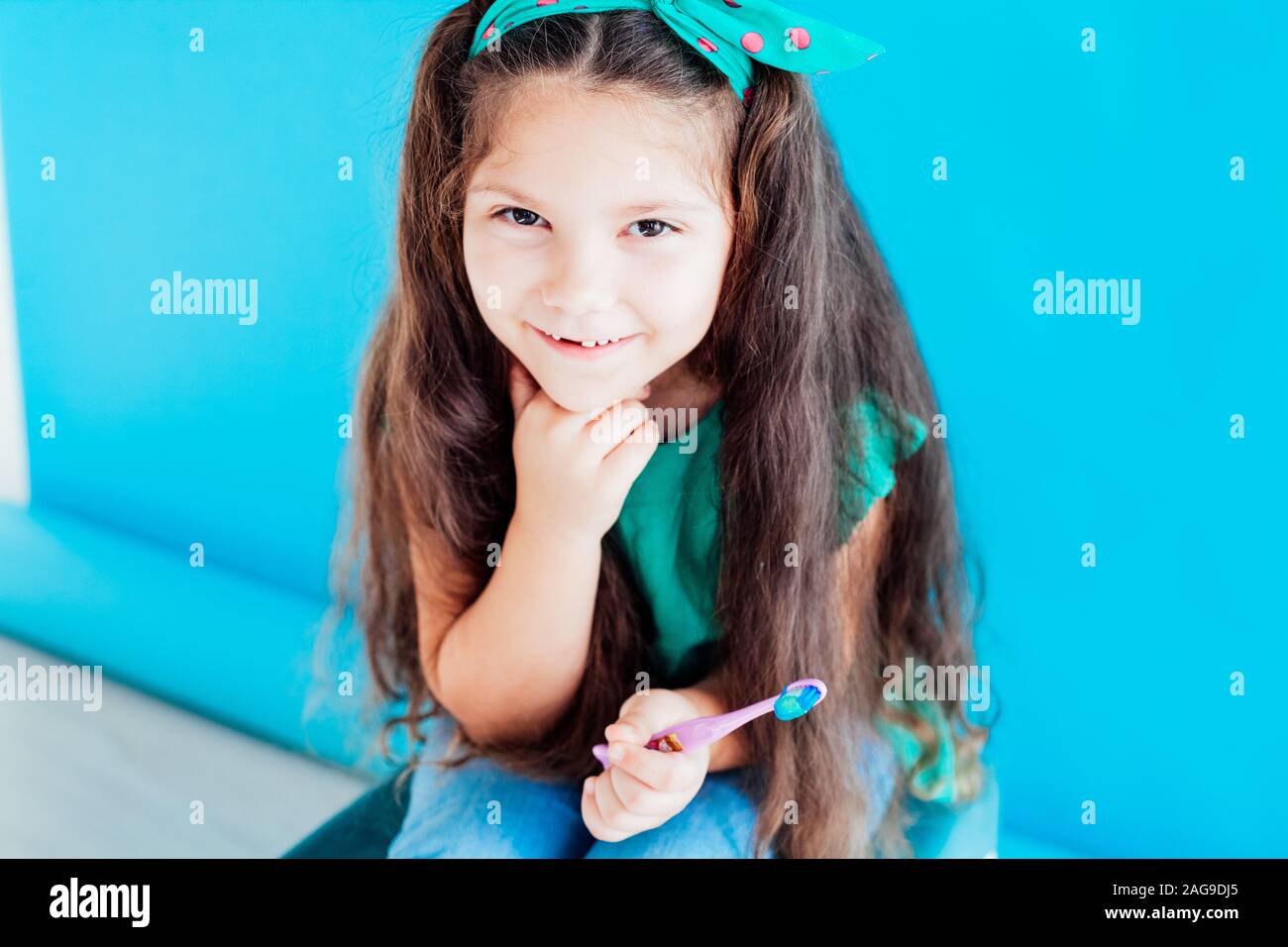 little girl with no teeth with a toothbrush in dentistry Stock Photo ...
