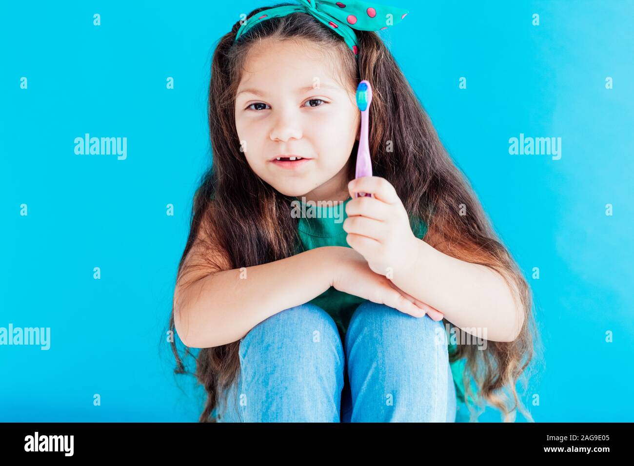 little girl with no teeth with a toothbrush in dentistry Stock Photo ...